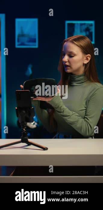 Vertical video Gen Z tech expert filming sponsored content, unboxing newly released VR glasses ...