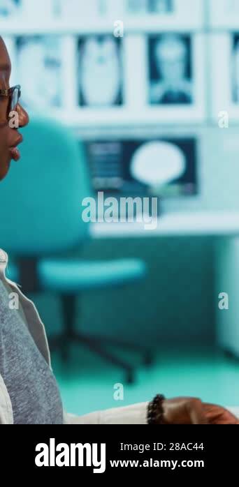 Vertical video Professional medic hosts a consultation with young ...