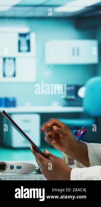 Vertical video African american specialist reviewing data and records ...