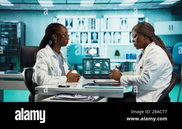 Healthcare professional consulting a female patient in a clinic office ...