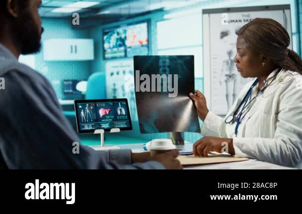 Medical professional explaining the x ray imaging for a diagnosis ...