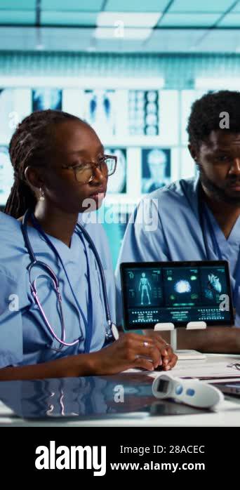 Vertical video Healthcare professionals discussing patient health ...