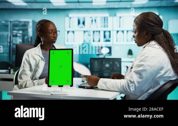 African american medic and patient discuss recovery plan next to green ...