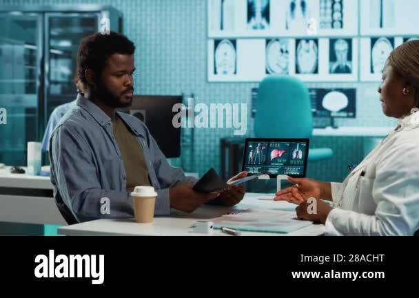 African american young man and specialist review ct scans and x rays ...