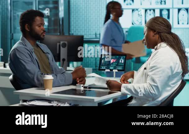 Medical interaction between a doctor and male patient with spinal pain ...