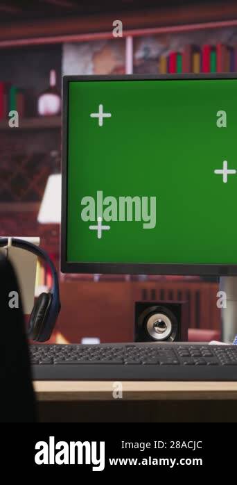 Vertical video Green screen computer monitor on wooden desk in modern ...
