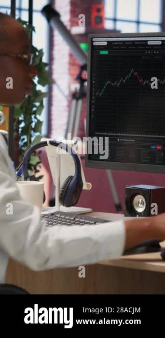 Vertical video Frustrated day trader feeling upset, looking at PC ...