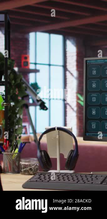 Vertical video Computer setup in bright apartment showing large language model program. PC ...