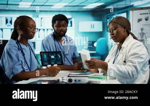 Male and female nurses in scrubs engaged in professional training and ...