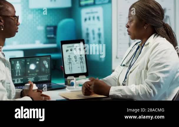Health specialist advising a young patient during a clinic checkup ...