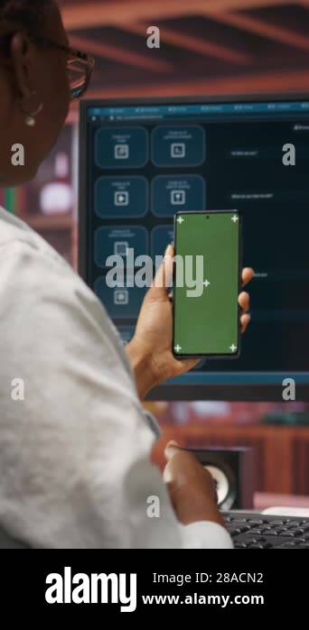 Vertical video Woman uses green screen phone, doing videocall in front ...