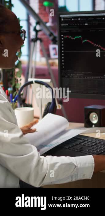 Vertical video Happy day trader using PC, feeling satisfied after ...