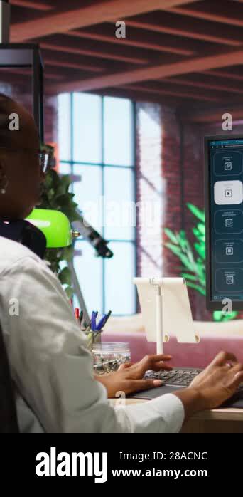 Vertical video Person at home getting tasks done with AI program turning text prompt into videos ...