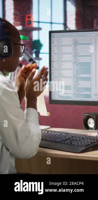 Vertical video Cheerful software developer at computer waiting for code ...