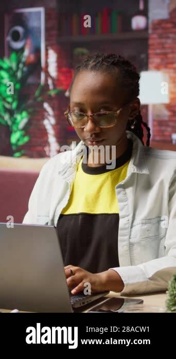 Vertical video Portrait of cheerful woman in home office opening laptop ...