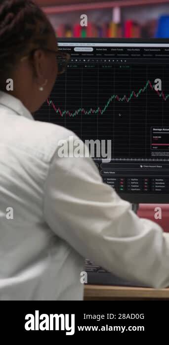 Vertical video Day trader using PC to purchase and sell stocks, reading files, aiming to ...