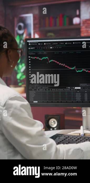 Vertical video Excited day trader gaining money by selling stocks after browsing through ...