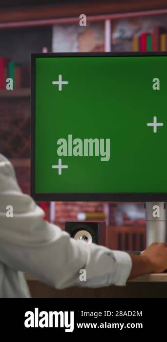 Vertical video Student at home browsing internet on green screen ...