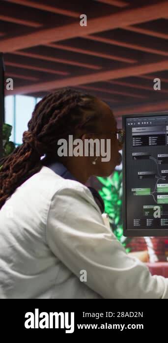 Vertical video Teleworking computer scientist at home using PC to develop artificial ...