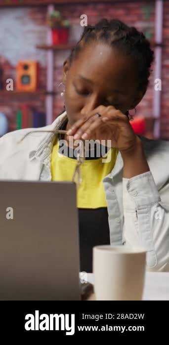 Vertical video Overworked freelancer in apartment trying to relax ...