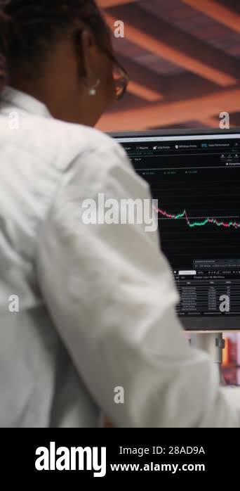 Vertical video Happy day trader using PC, feeling satisfied after ...