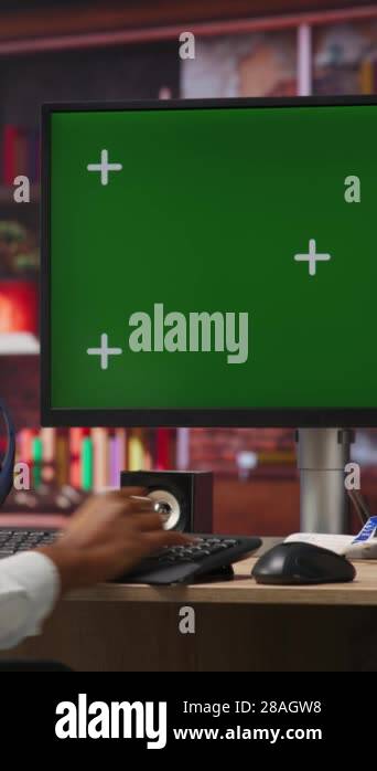 Vertical video Teleworker using green screen PC in home office to write emails. Remote worker ...