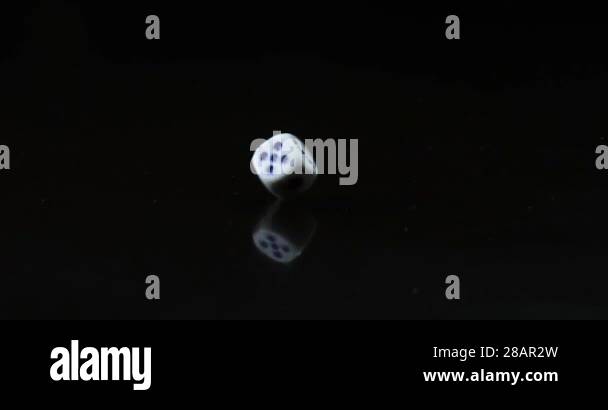 spinning dice on the dark background Stock Video Footage - Alamy