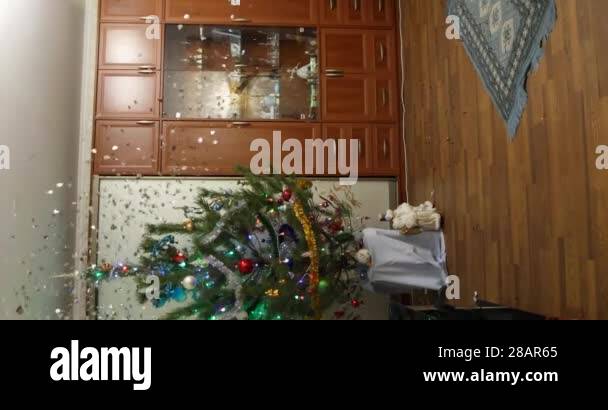 exploding party popper with confetti on christmas tree with decorations ...