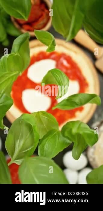 Concept of Pizza Preparation with Flying Basil Leaves from Above ...