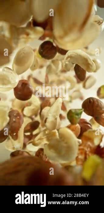 Super Slow Motion of Flying Nuts Mix in Rotating Movement. Filmed on ...