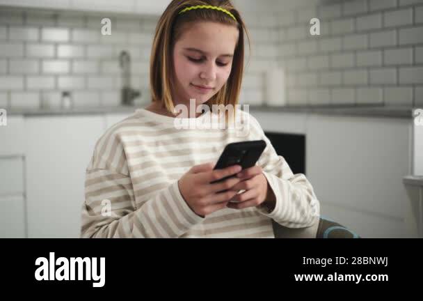 Cute Little Girl Surfing The Internet On Smartphone And Chatting With ...