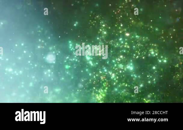 Multi colored particles flying on a dark black background in an ...