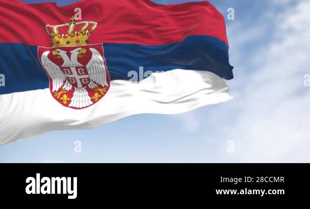 Serbia national flags waving in the wind on a clear day. Red, blue, and ...