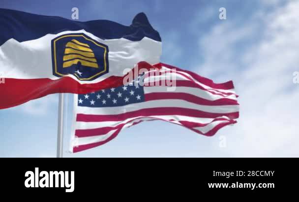 The Beehive Flag of Utah and the american flag waving on a clear day ...
