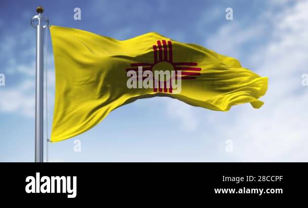 New Mexico state flag waving in the wind on a clear day. Red sun symbol ...