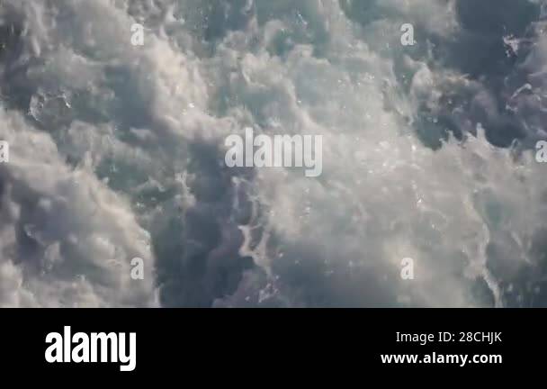 Blue ocean sea water wave with fast yacht boat wake foam of prop wash ...