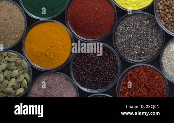 Different spices and herbs on background rotating, close up, top view ...