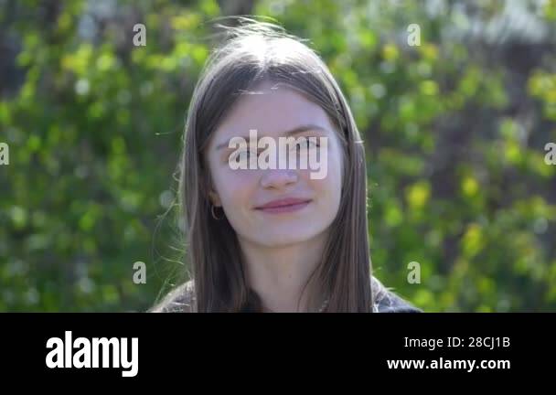 Portrait of a beautiful happy girl with blond hair and freckles looking ...