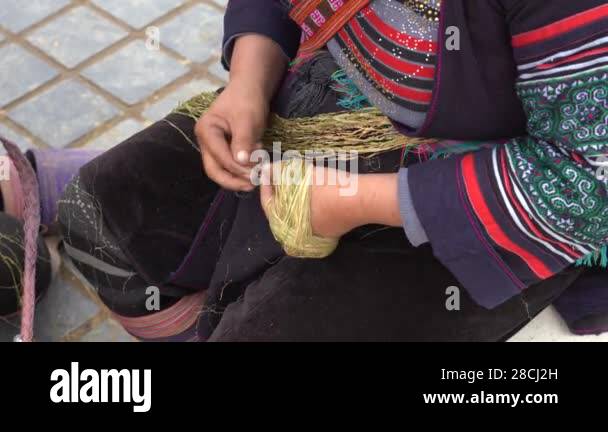 Hands of a Vietnamese woman weave thread in a local mountain village in ...