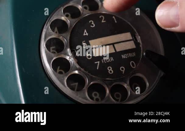 Man dialing numbers on an old vintage rotary style telephone. Retro ...