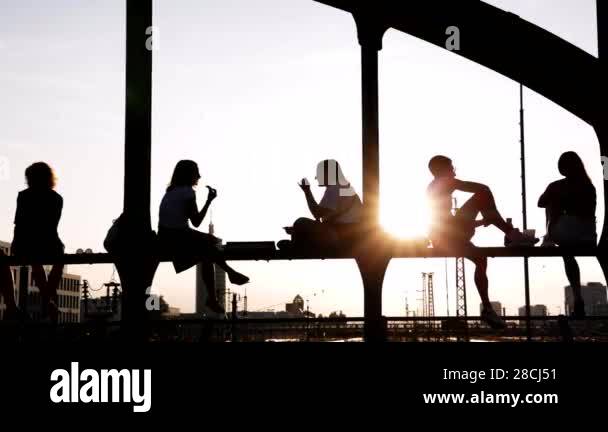 Young people city dwellers enjoying the sunset after work free time ...