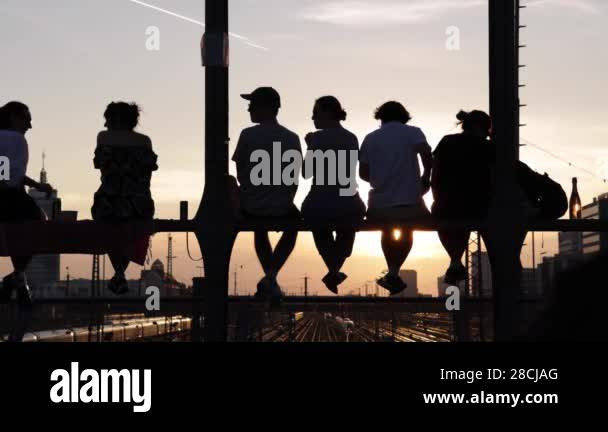 Young people city dwellers enjoying the sunset after work free time ...