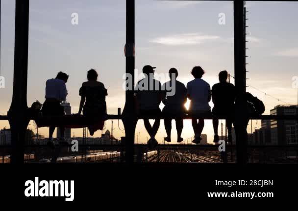 Young people city dwellers enjoying the sunset after work free time ...