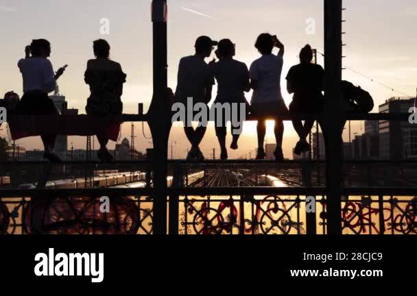 Young people city dwellers enjoying the sunset after work free time ...