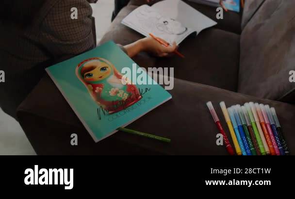 An artist happily engages in a vibrant coloring activity, using ...