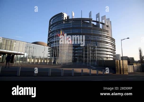 European parliament building and poles with national flags of european ...