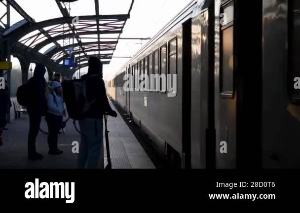 Train arriving on trains station early in morning Stock Video Footage - Alamy