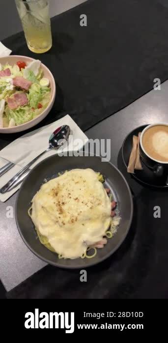 Romantic dinner for two in a restaurant on a black table, pasta ...