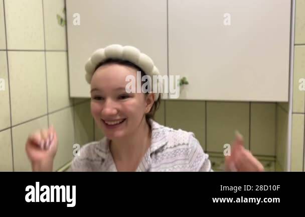 Young brunette woman washing cleaning face with organic foamy soap ...