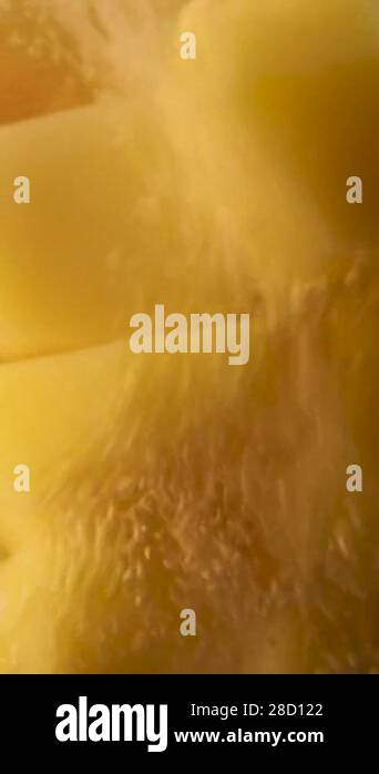 Delicious, bright yellow potatoes are cooked in a shiny silver-colored ...